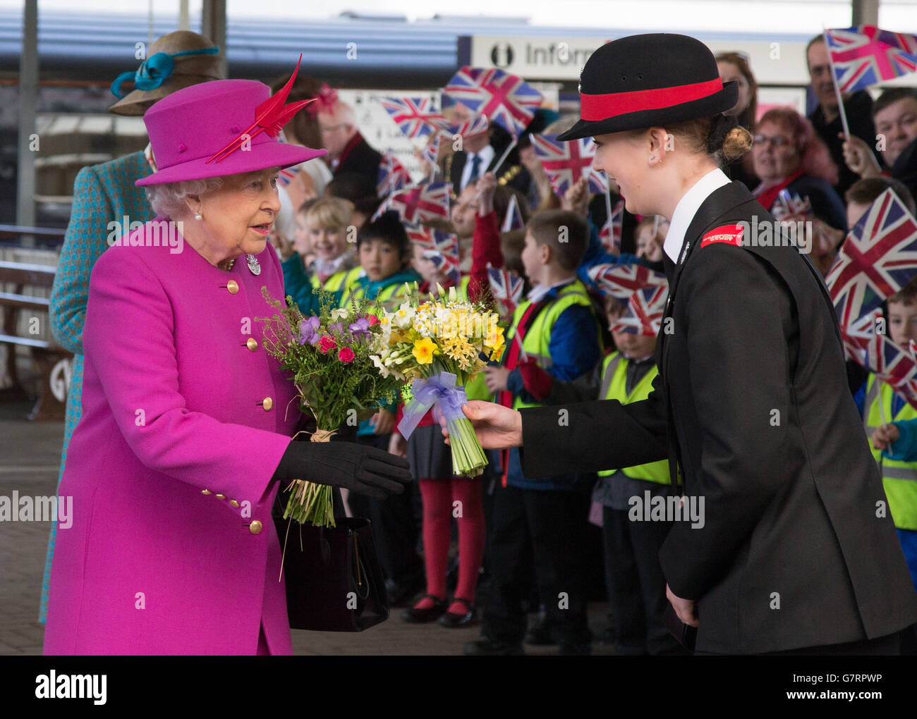 Queen Elizabeth II is presented with flowers by Lord Mayor's cadet ...