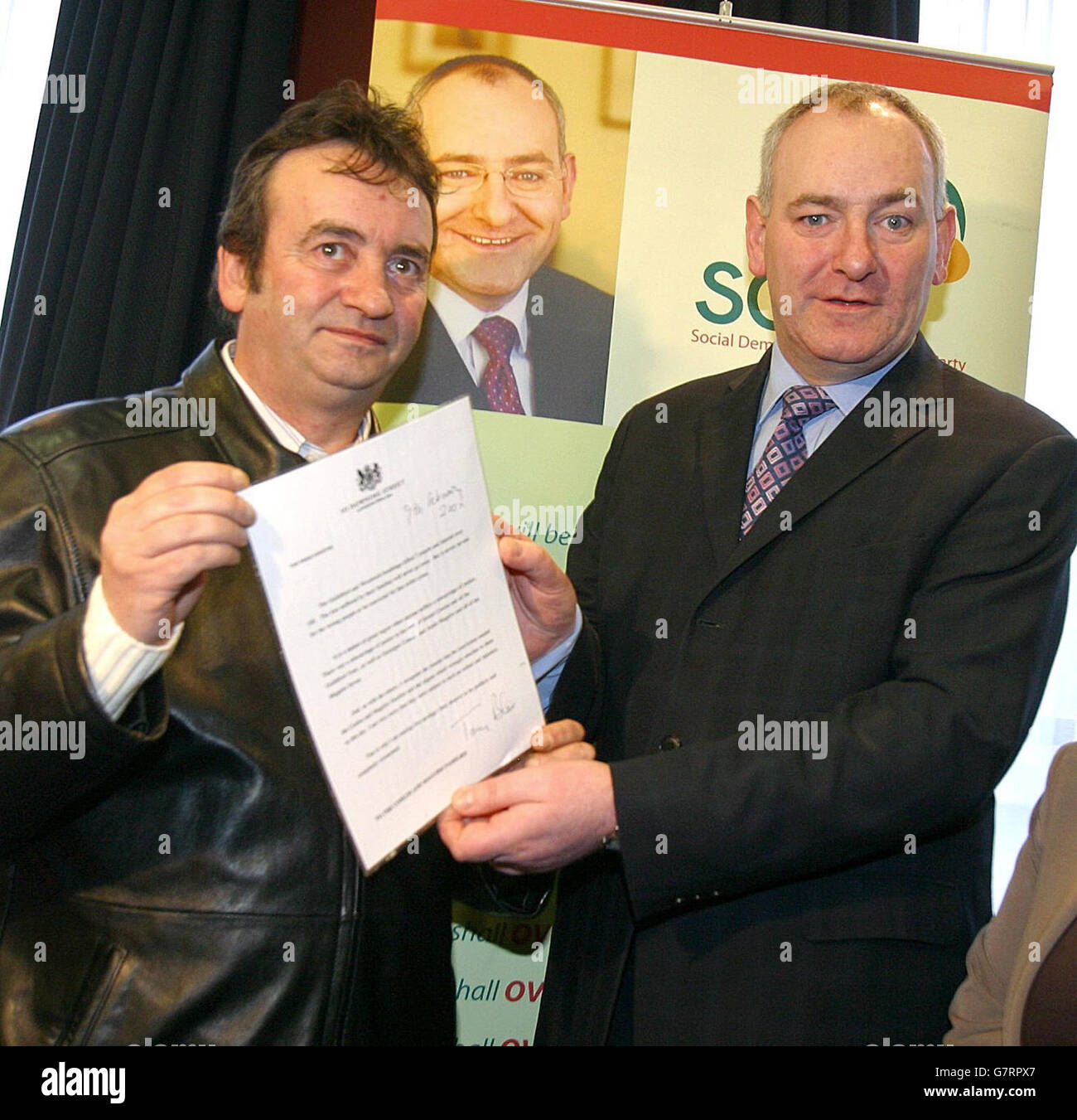 Gerry Conlon (L), with SDLP Leader Mark Durkan, showing his letter of ...