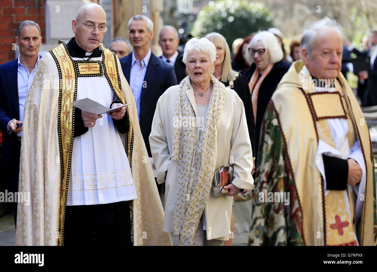 Dame Judi Dench (centre) alongside Reverend Simon Grigg (left) as they ...