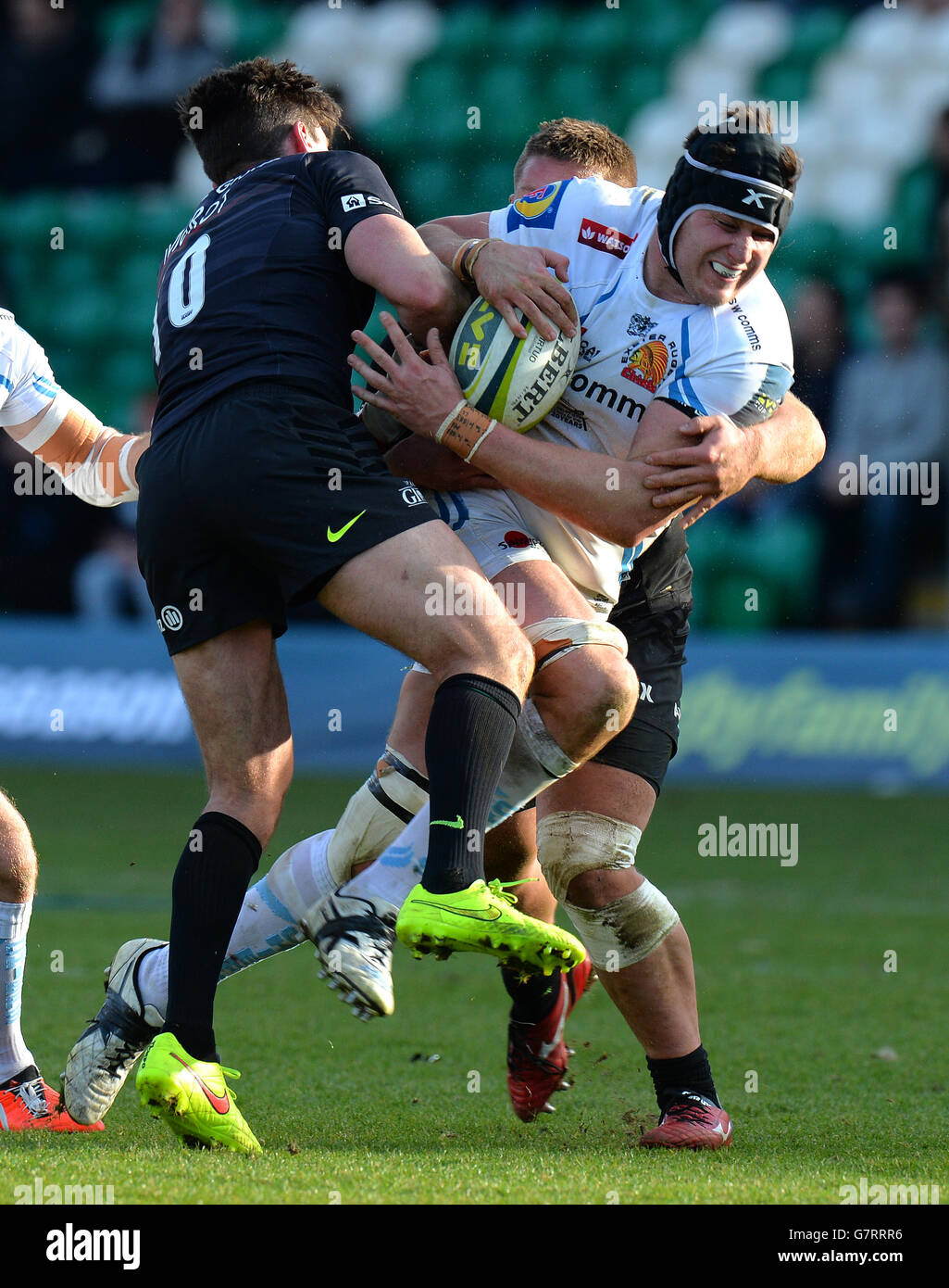 Richard Barrington and Nils Mordt of Saracens tackle Mitch Lees of ...
