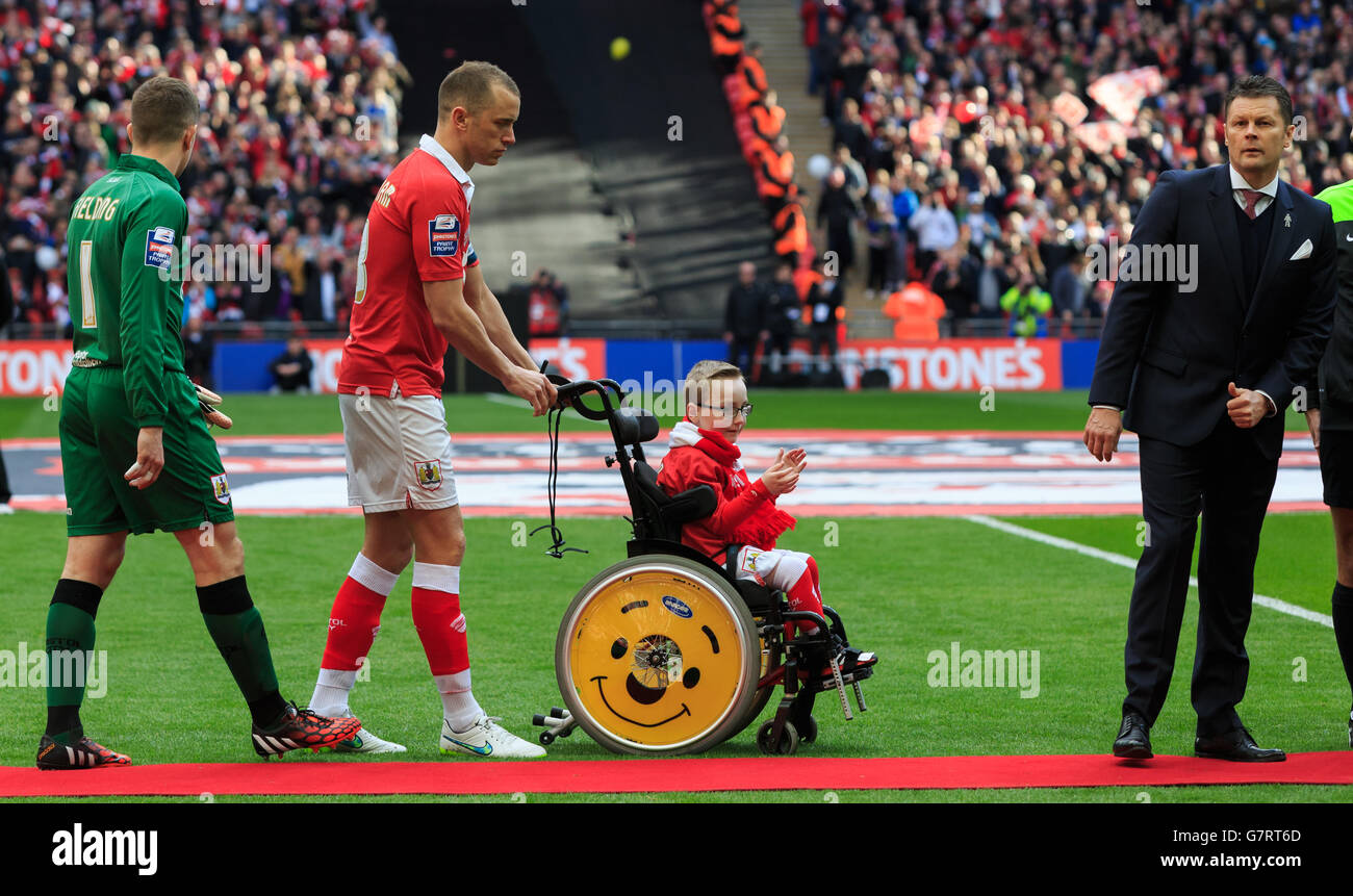 Bristol City captain Aaron Wilbraham pushes the mascot watched by ...