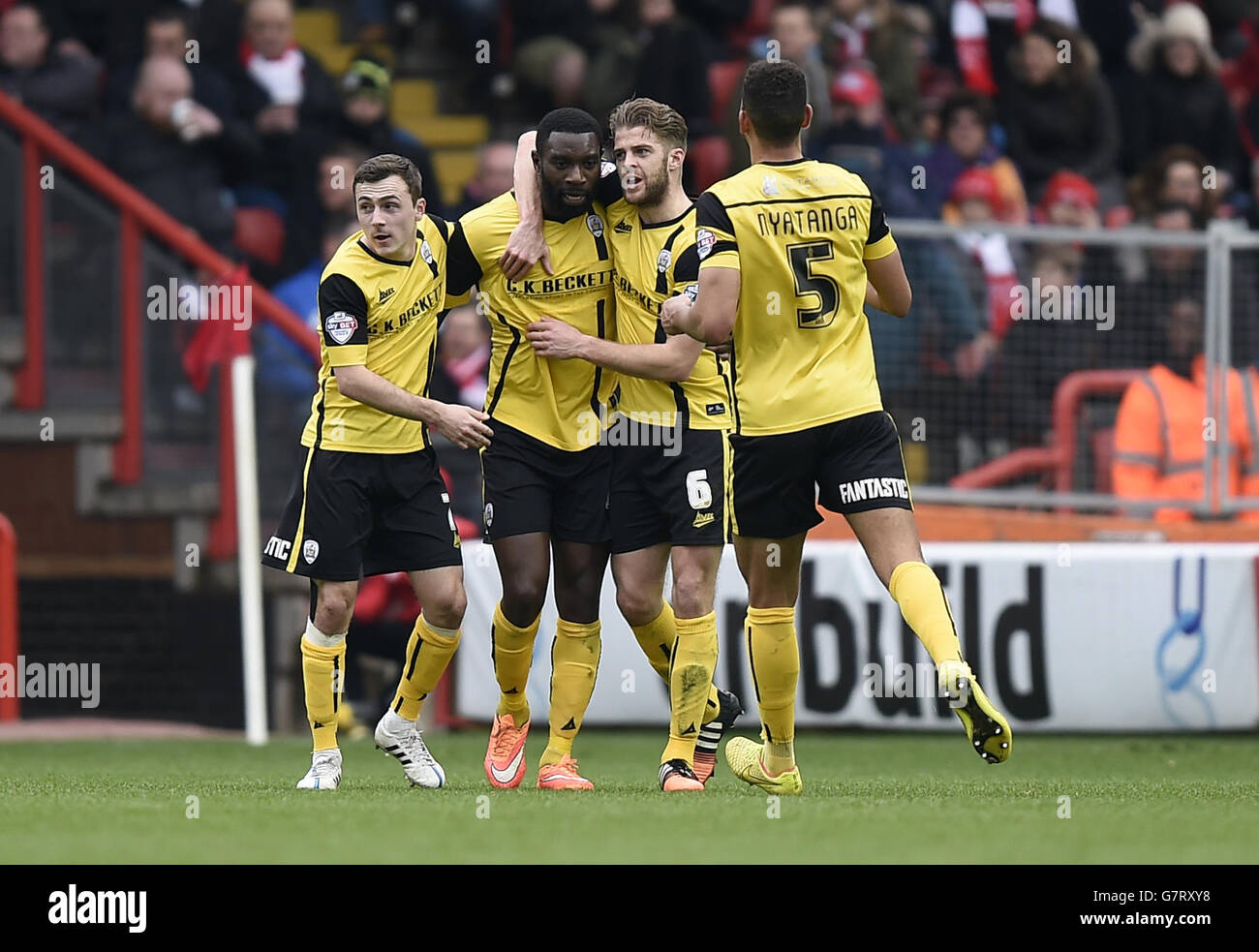 Barnsley's Jabo Ibehre (2nd left) celebrates with his team mates after ...