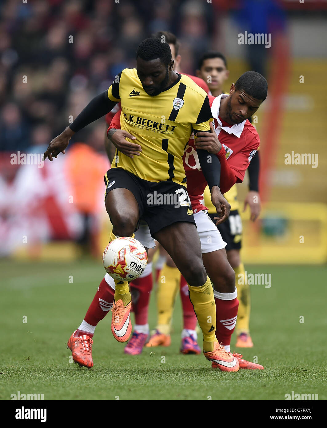 Barnsley's Jabo Ibehre (left) and Bristol City's Mark Little battle for ...