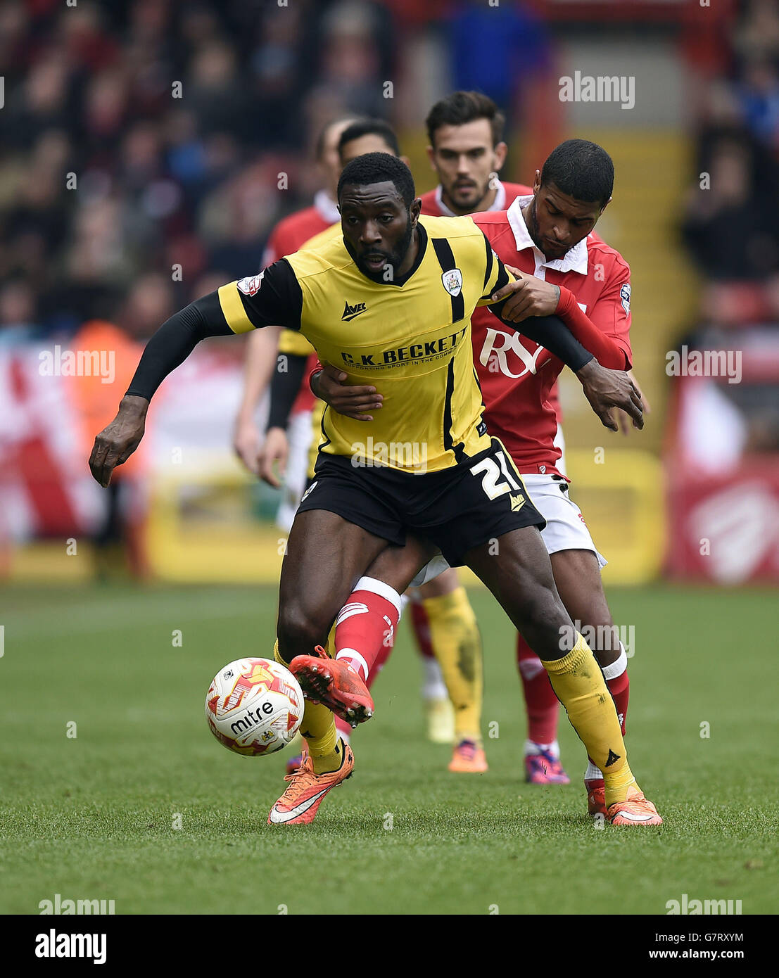 Barnsley's Jabo Ibehre (left) and Bristol City's Mark Little battle for ...