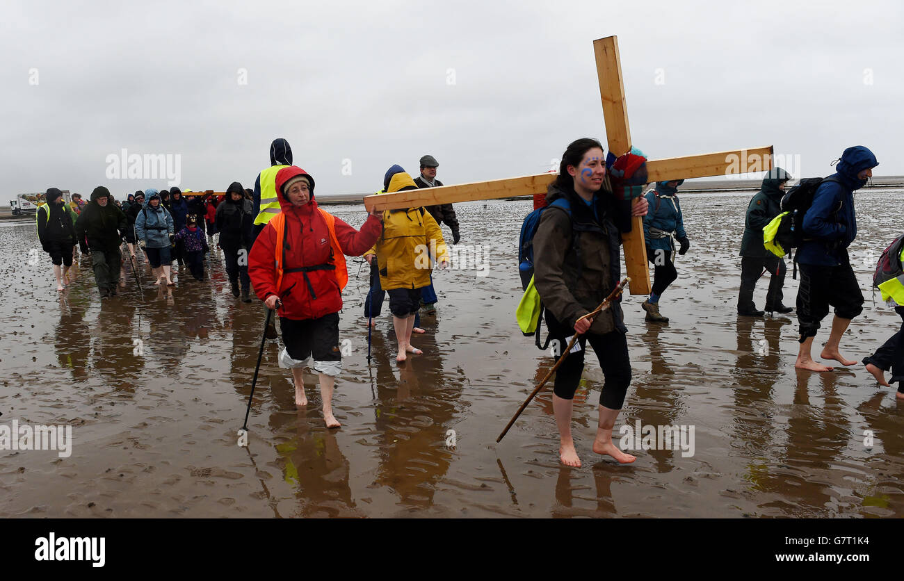 Caroline Wilson (front) carries a cross as she joins pilgrims crossing ...