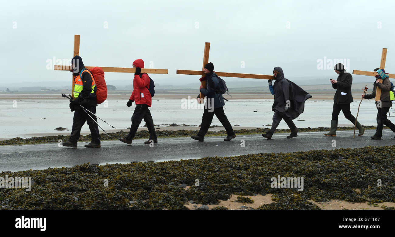 Pilgrims carrying crosses as they cross from Beal sands to the Holy ...