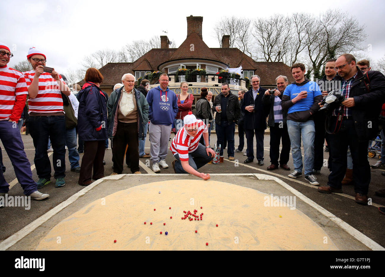A member of the Where's Tolley marbles team takes a shot in a game ...