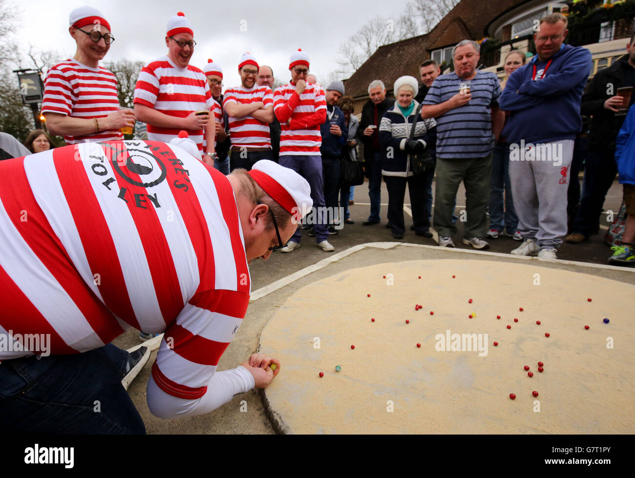 A member of the Where's Tolley marbles team takes a shot in a game ...