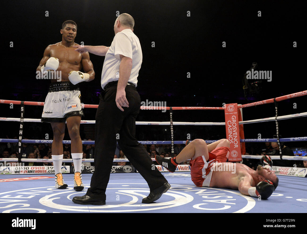 Anthony Joshua (left) reacts after knocking down Jason Gavern during ...