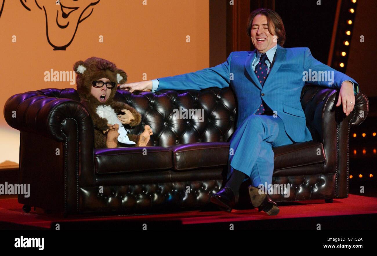 Celebrity showbiz charity comedian sitting on stage hi-res stock ...