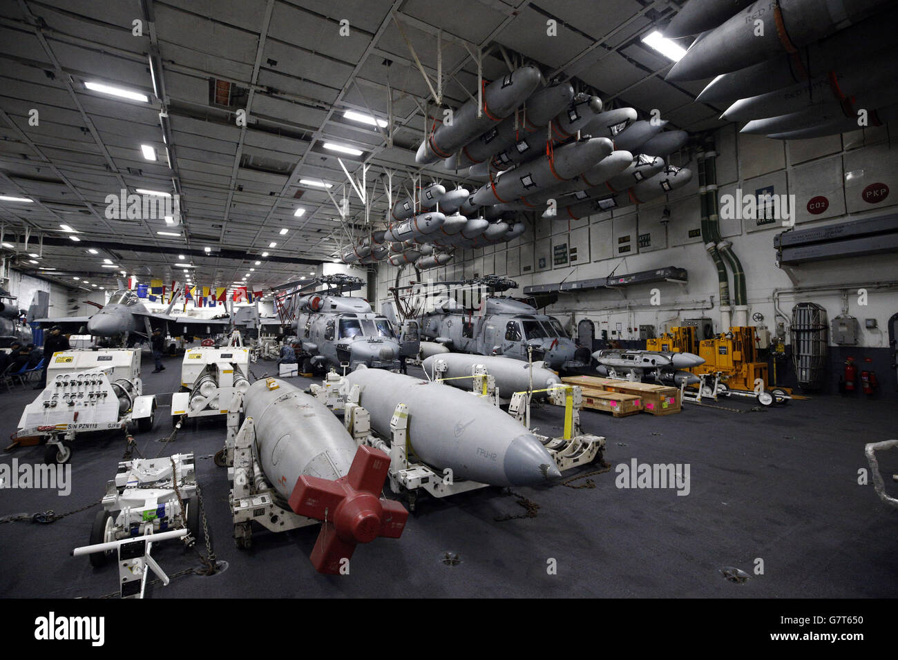 Aircraft and ordnance in a hangar aboard the US aircraft carrier USS ...