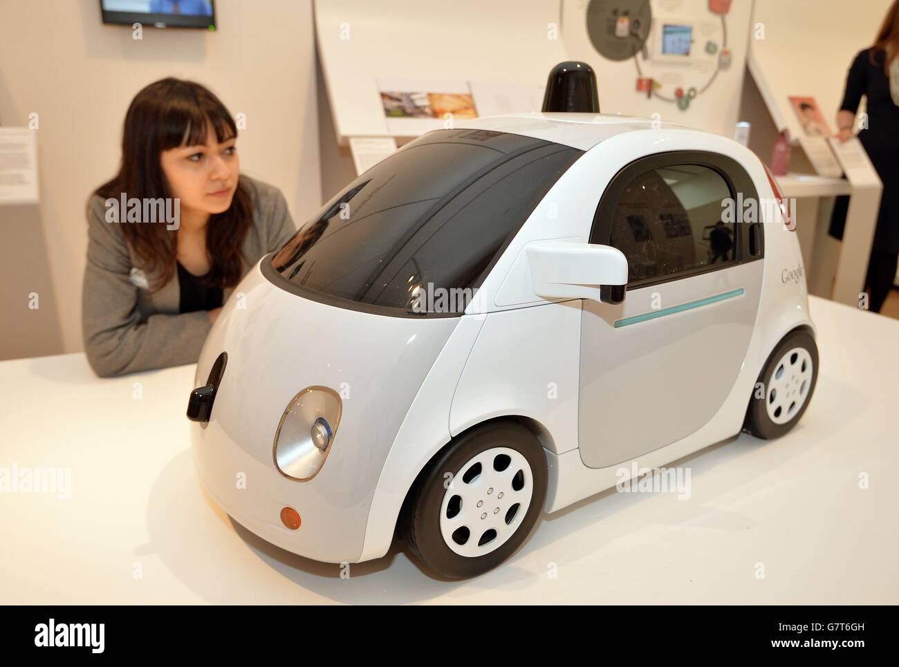 A woman studies the Google driverless car model, which is one of the 76 ...