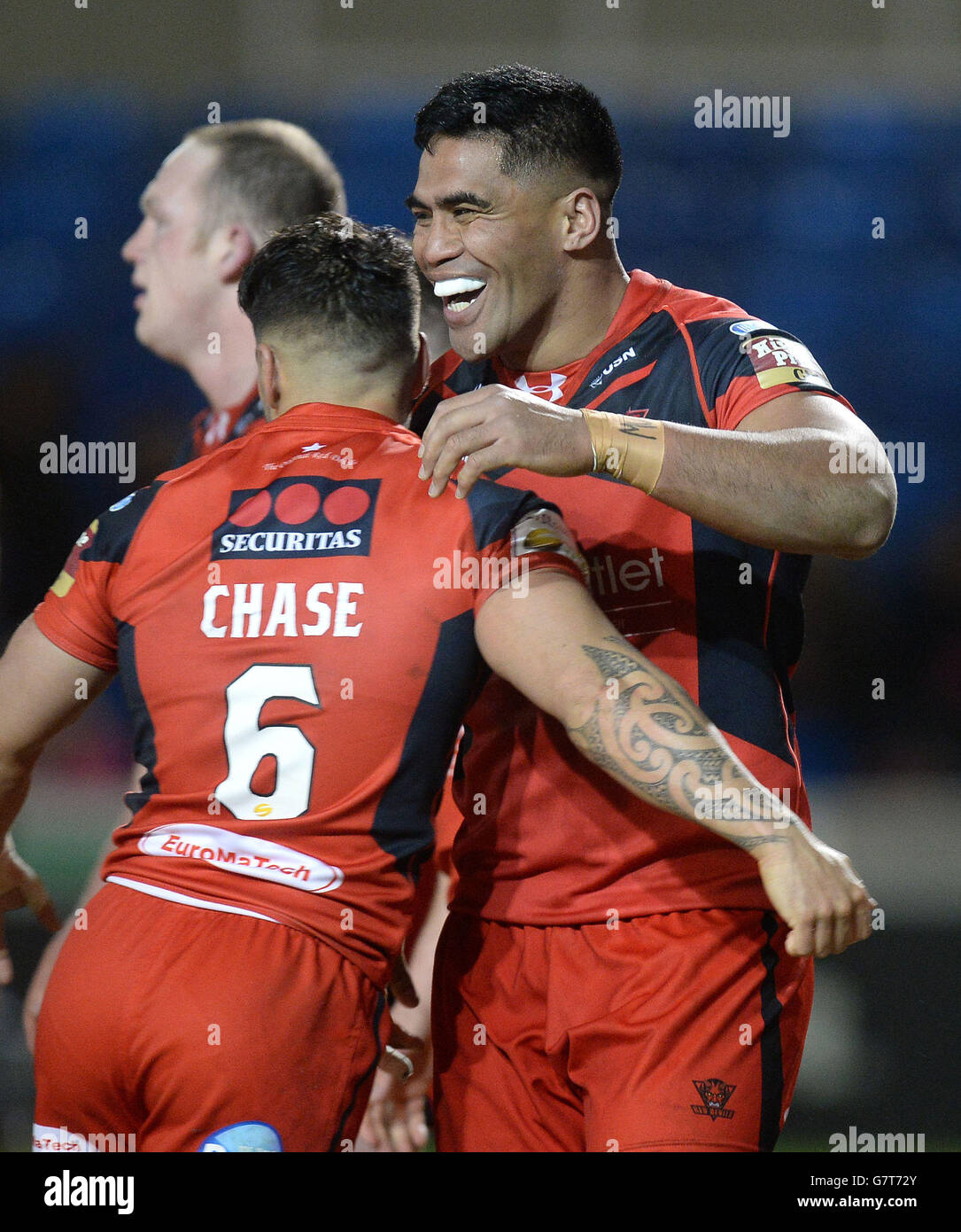 Salford Red Devils' Lama Tasi (right) celebrates his try against Widnes ...