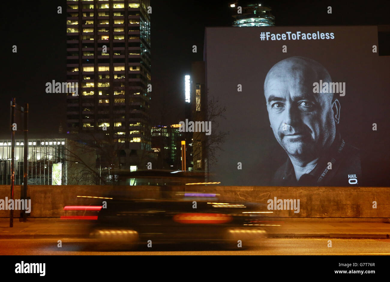 A portrait of Micky Eales, a London cabbie, is projected onto Waterloo ...