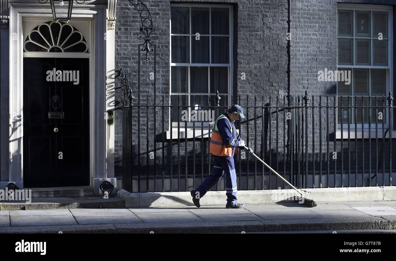 A road sweeper makes his way past 10 Downing Street, London, as one of ...
