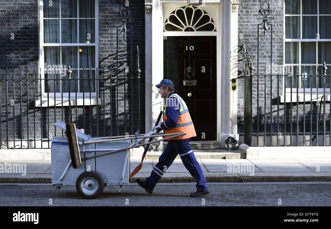 A road sweeper makes his way past 10 Downing Street, London, as one of ...
