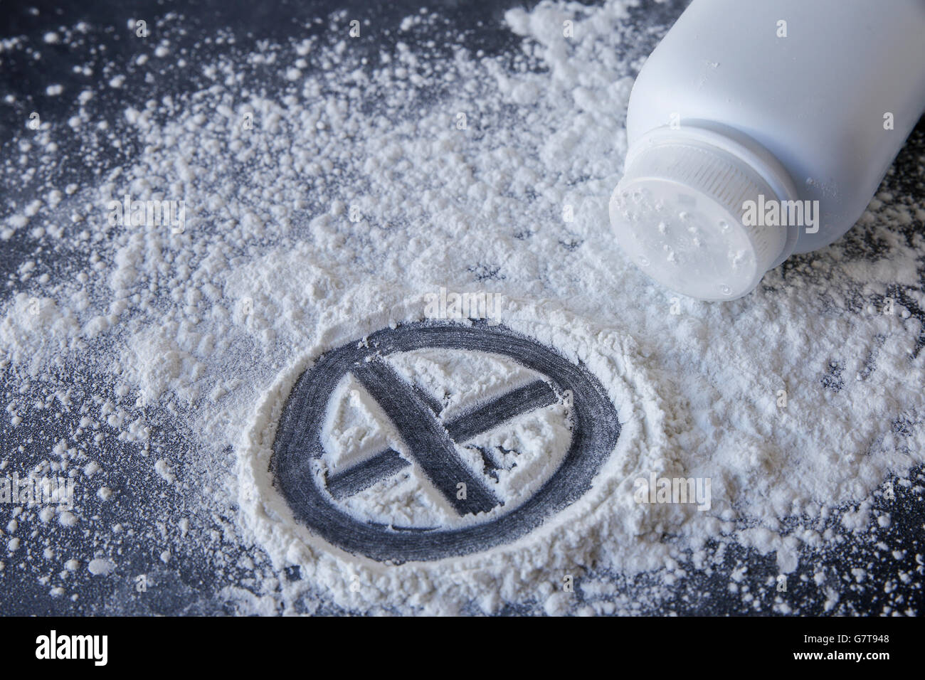 Talcum powder with cross sign on black background Stock Photo - Alamy