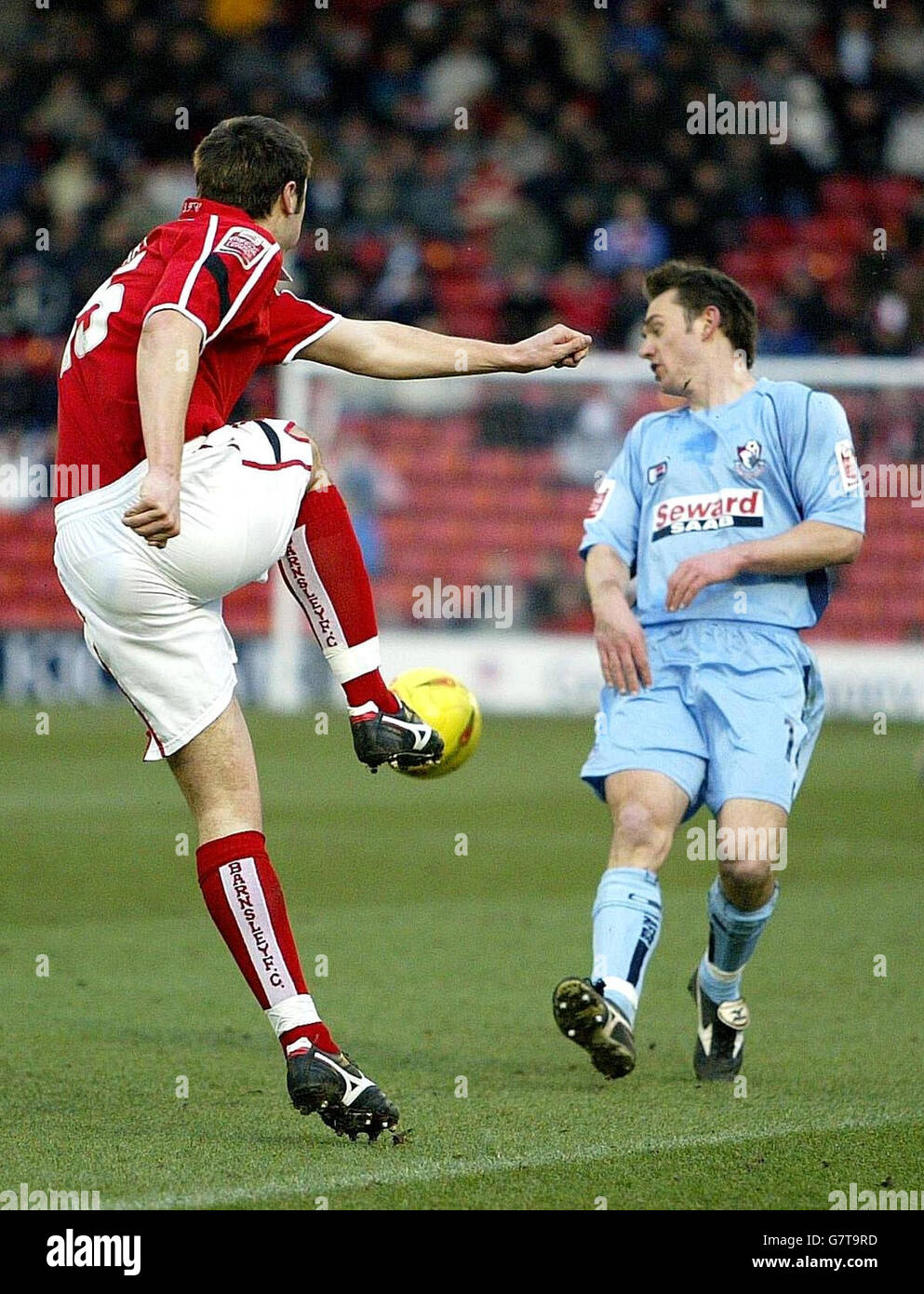 Barnsley's Antony Kay (left) clears the ball as Bournemouth's Gareth O ...