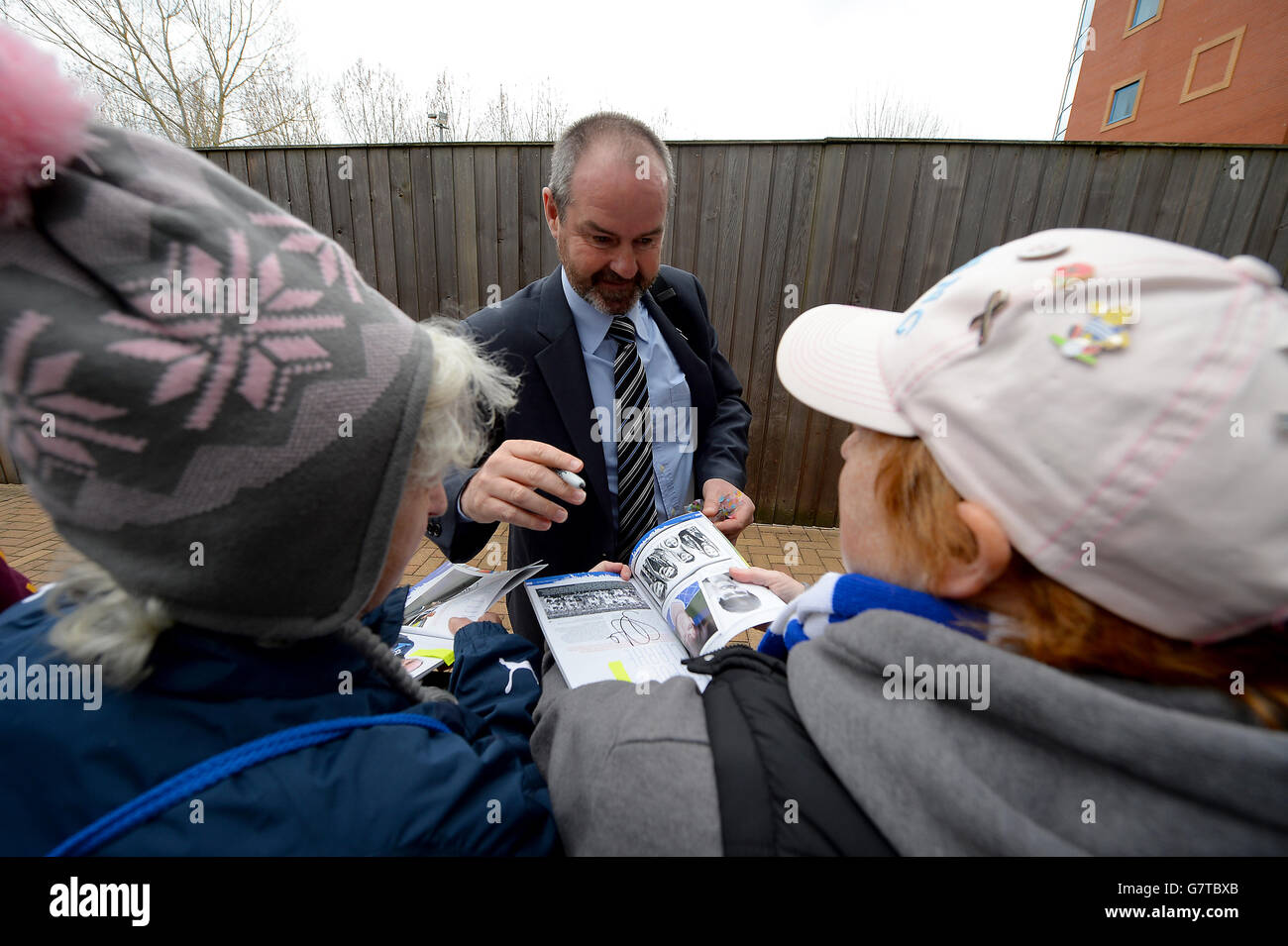 Reading manager Steve Clarke signs autographs for fans outside the ...