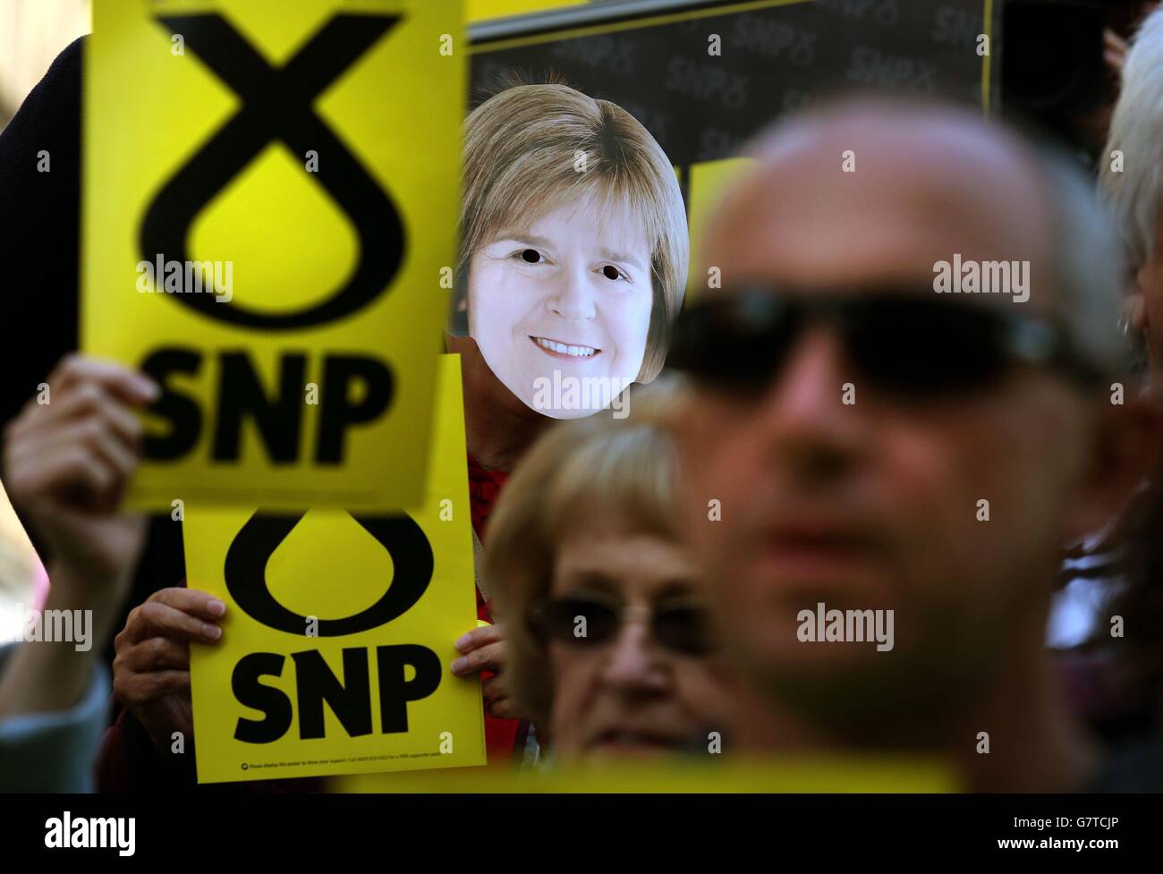 An activist wears a mask with a picture of SNP leader and First ...