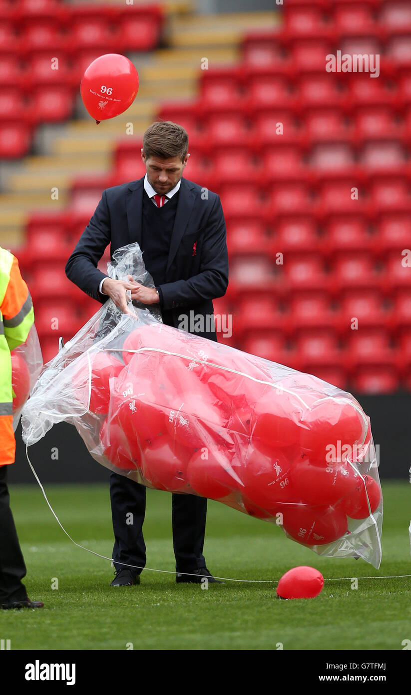 Liverpool captain Steven Gerrard (right) releases 96 balloons during ...