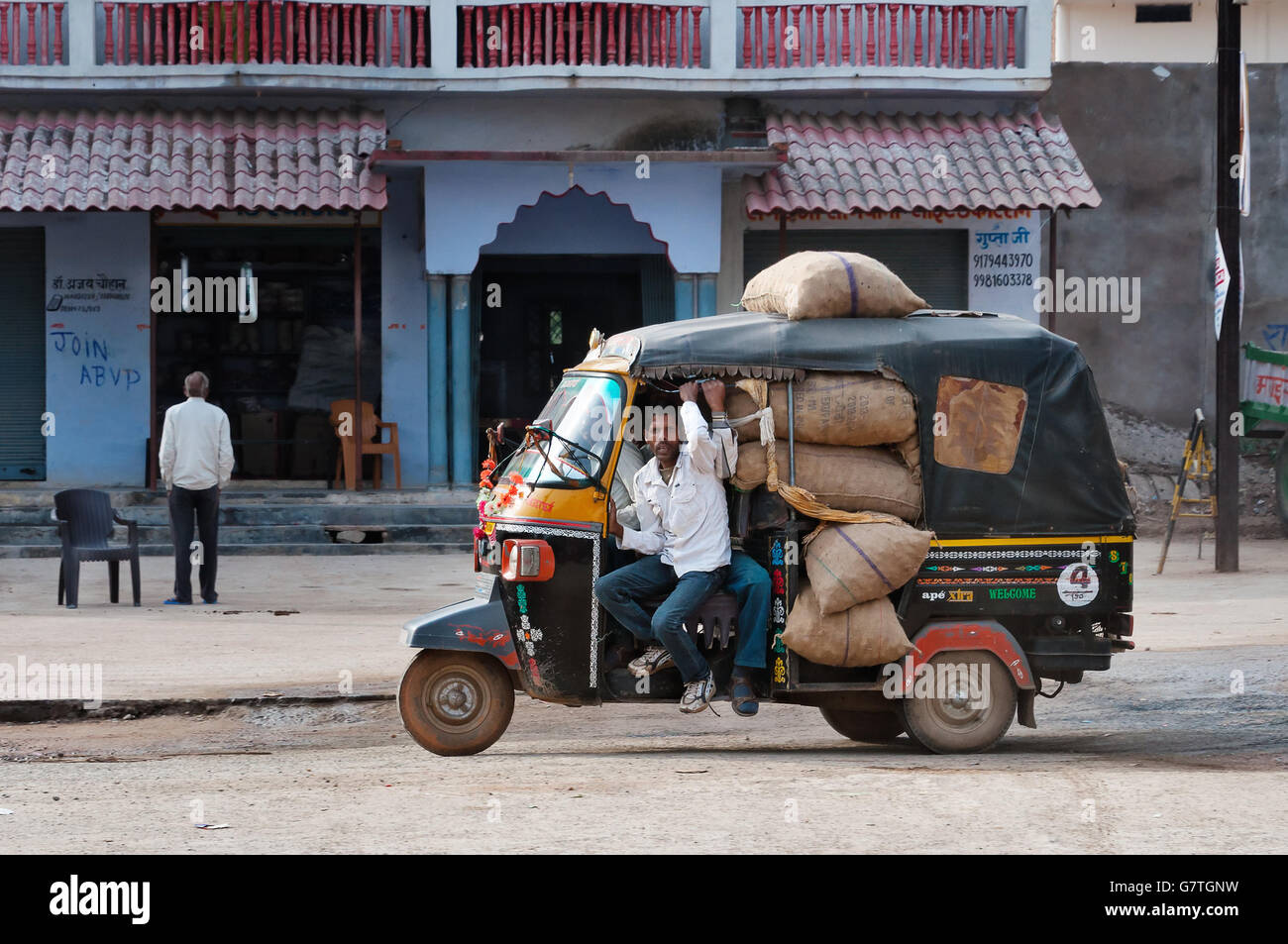 Indian rickshaw with driver full of bags on the road Stock Photo - Alamy