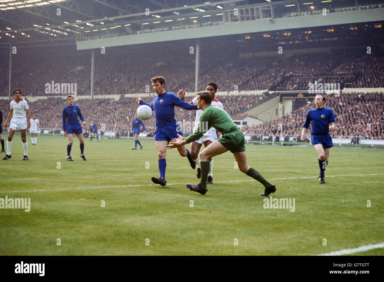 Manchester United goalkeeper Alex Stepney (second r) comes out to ...