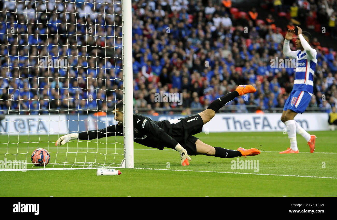 Reading goalkeeper Adam Federici scrambles for the ball after letting ...