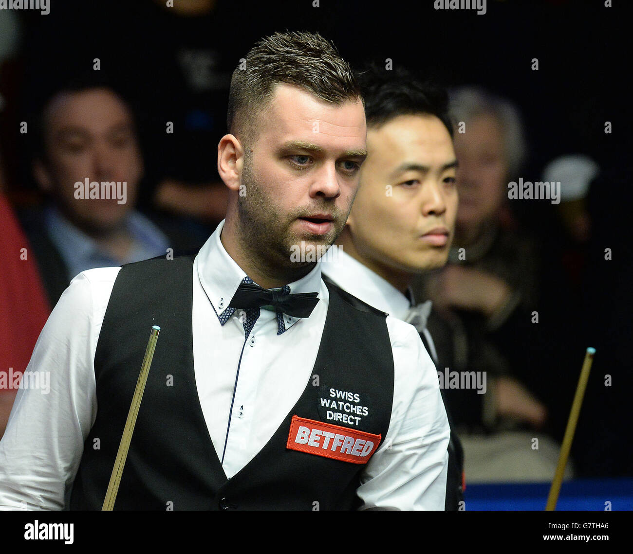 Jimmy Robertson (left) and Marco Fu look at the table in their match ...