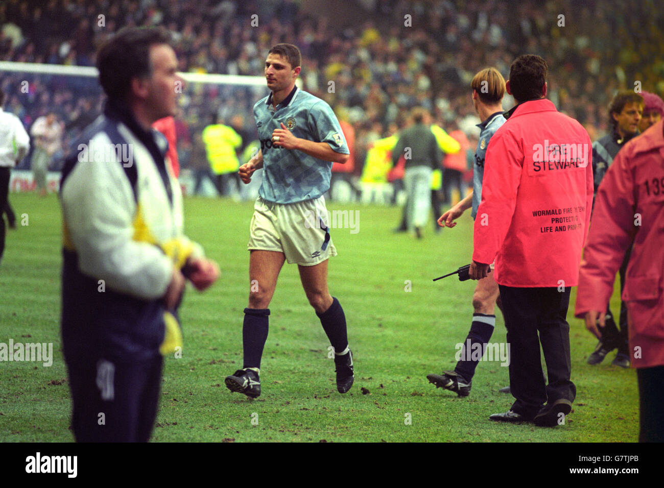Manchester City's Michel Vonk leaves the pitch as police and stewards ...