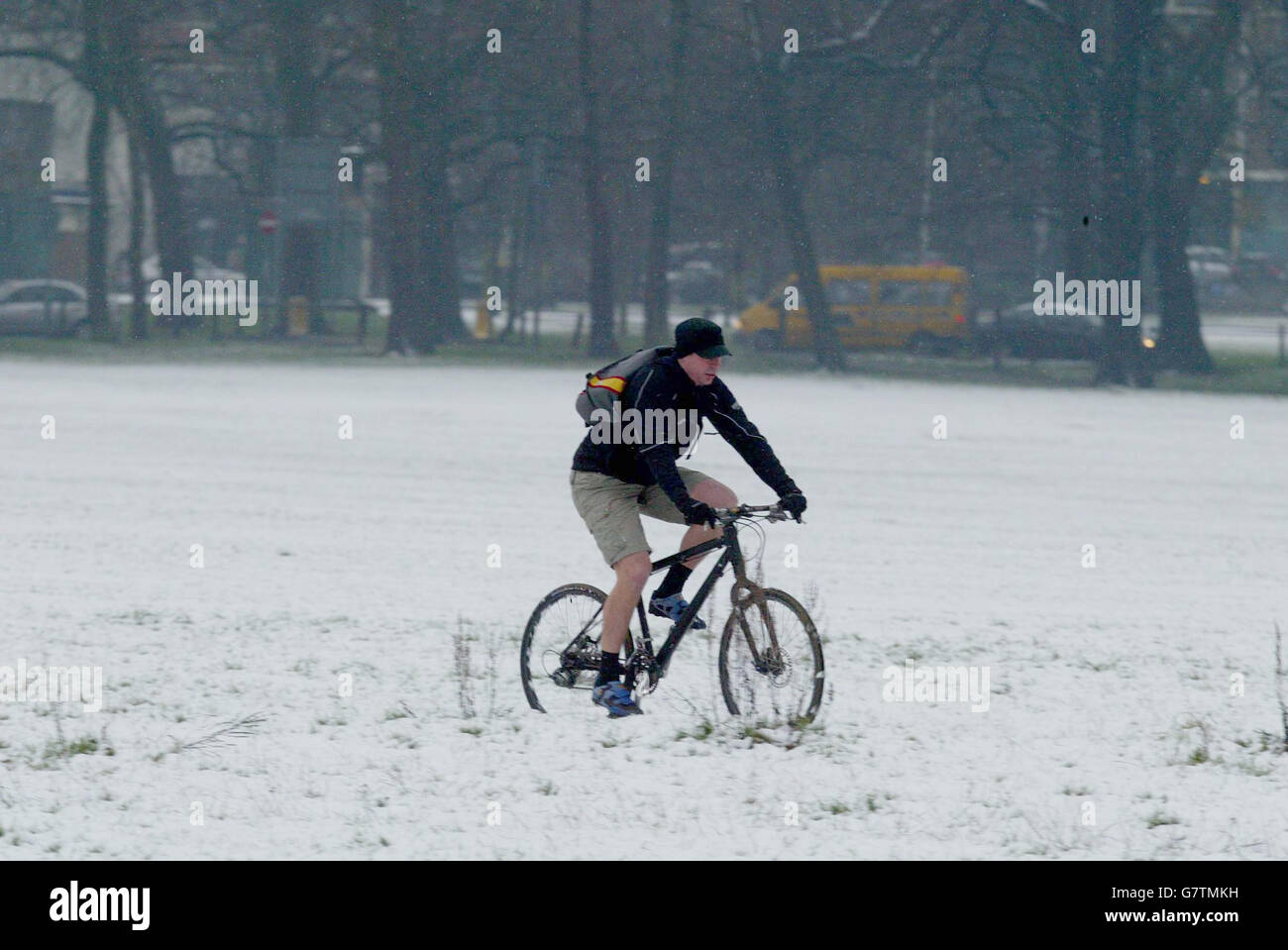 A Londoner cycles across Clapham Common as London received a covering ...