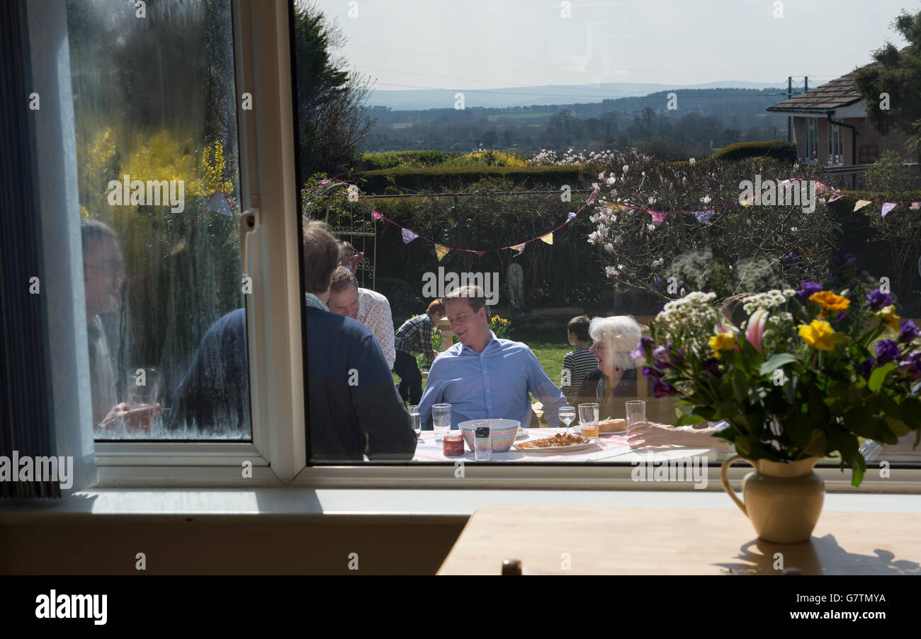 Prime Minister David Cameron (centre) eats lunch in a garden with the ...