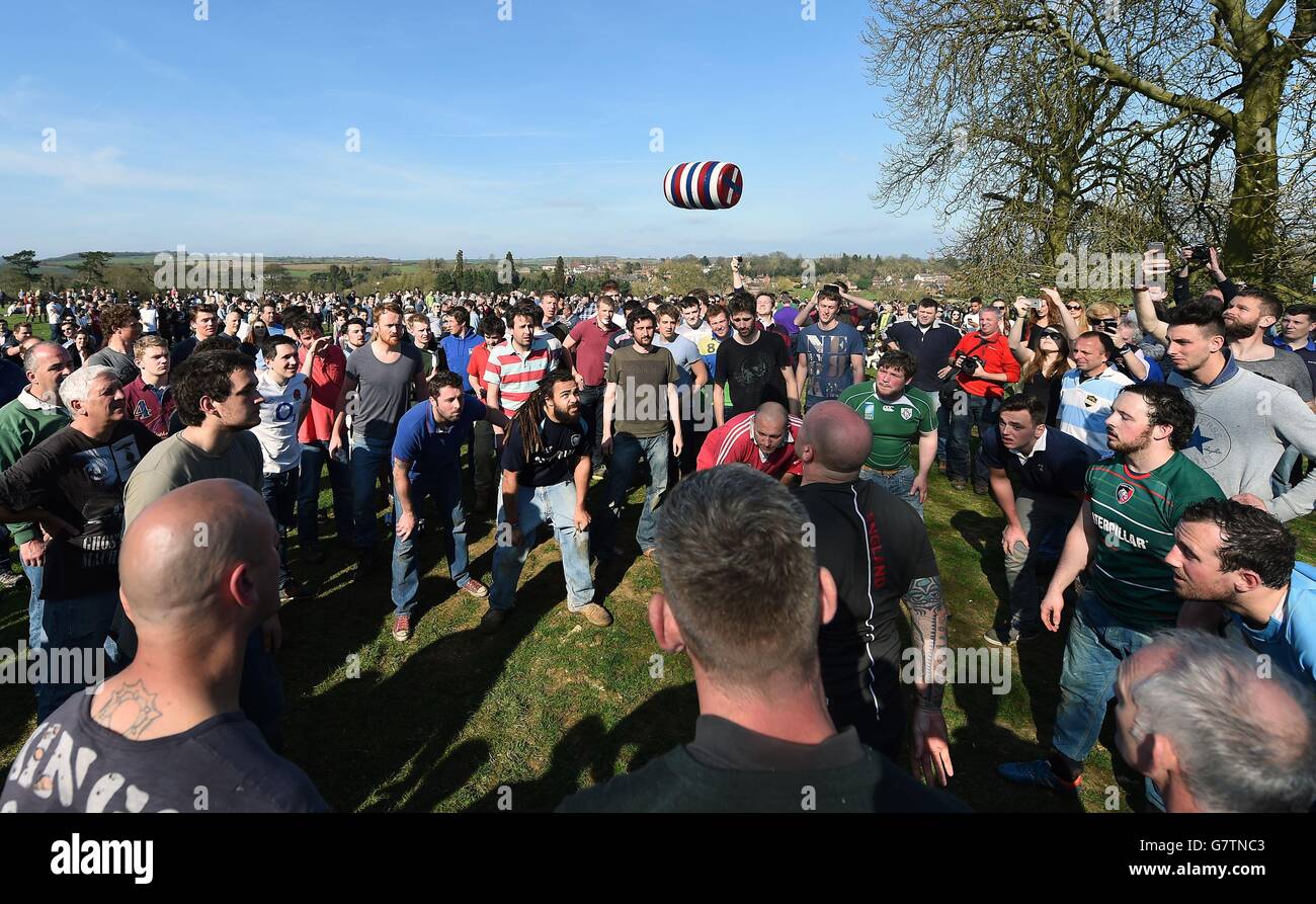 Players from both teams keep a close eye on the keg as it is tossed up ...