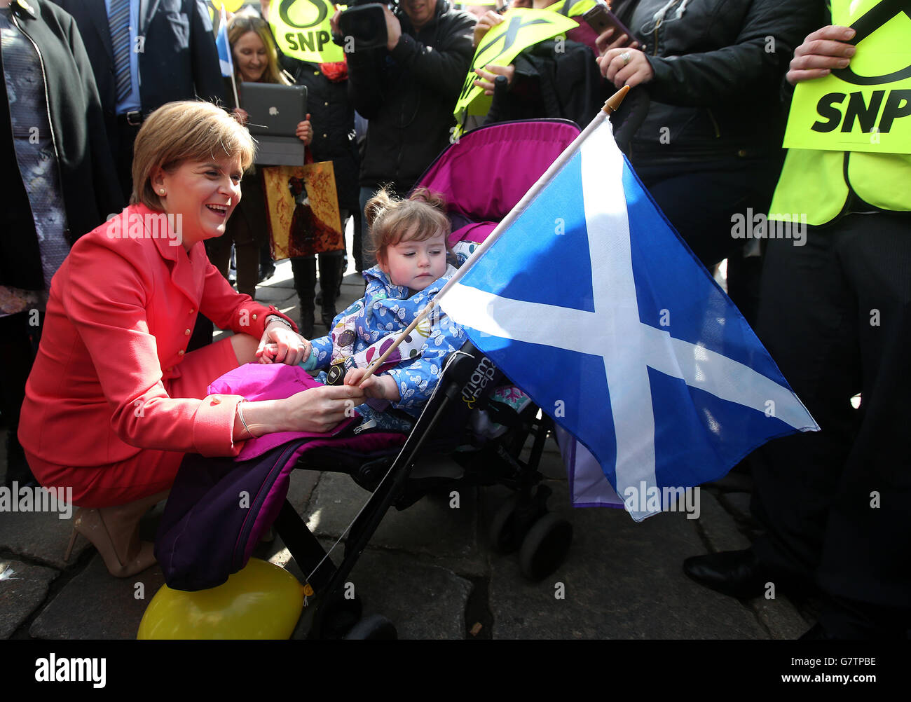 Two year old Eloise Kilpatrick waves a flag with First Minister Nicola ...