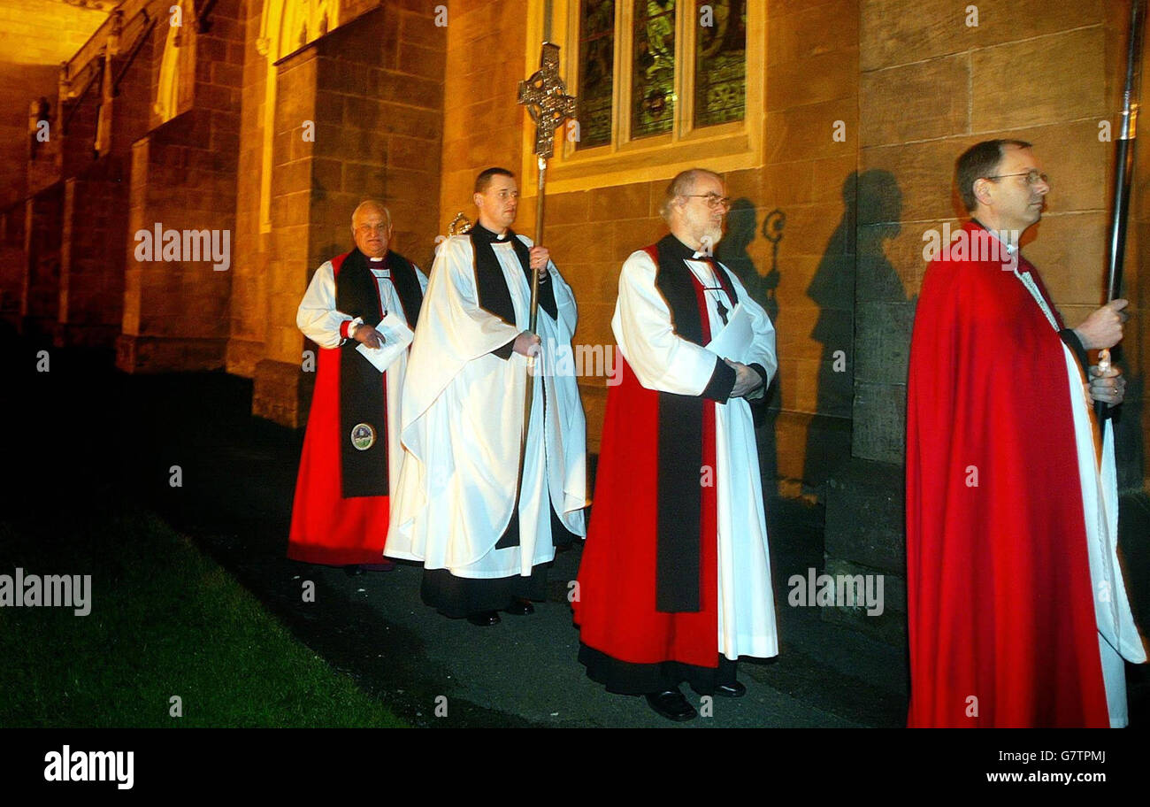 Archbishop Robin Eames (left) makes his way with the Archbishop of ...
