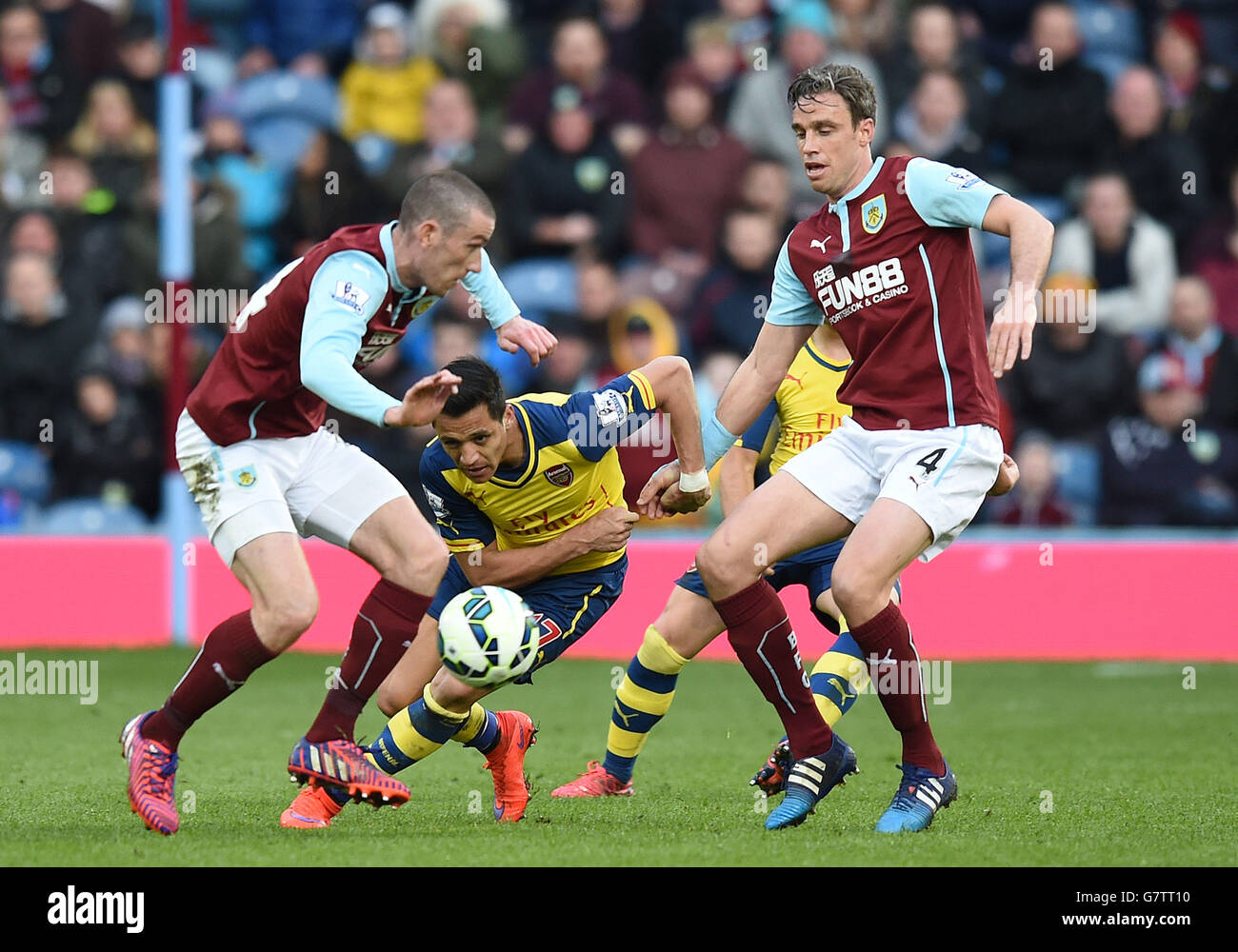 Arsenal's Alexis Sanchez takes on Burnley's Michael Duff and David ...