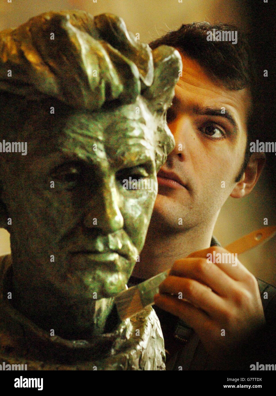 A bust of W.S.Graham is cleaned by Sergio Merida before a display of ...