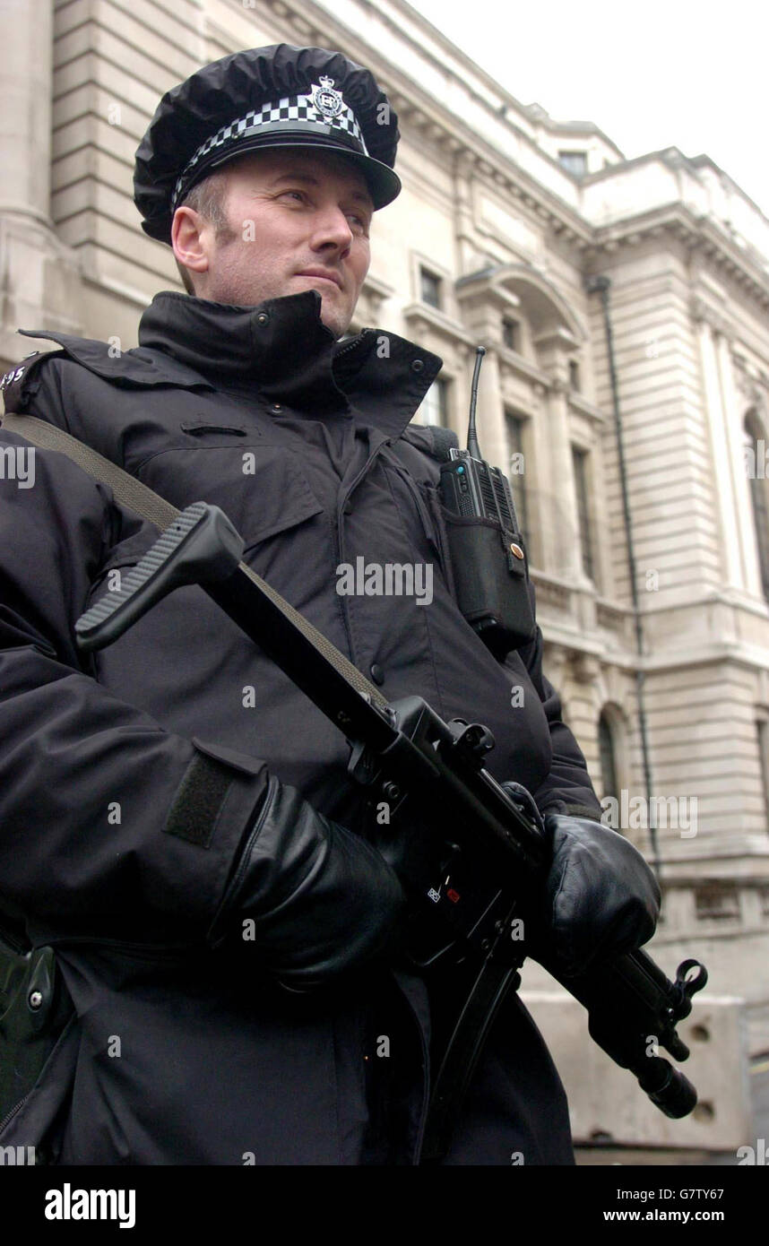 An armed police officer stands guard outside the Queen Elizabeth II ...