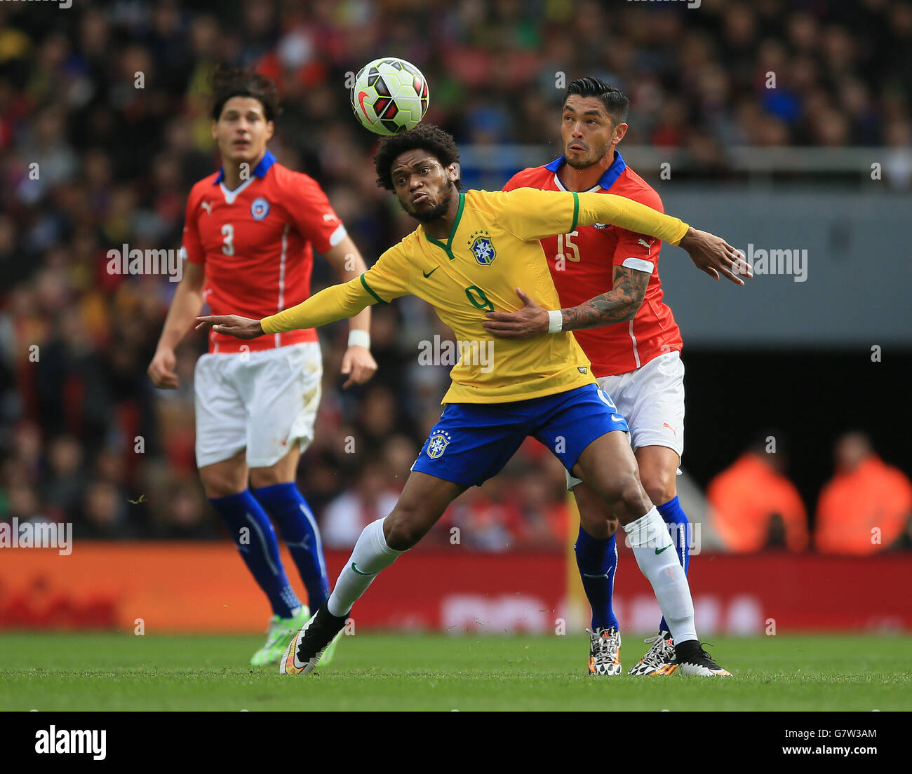 Chile's Rodrigo Millar (right) battles for the ball with Adriano (left ...