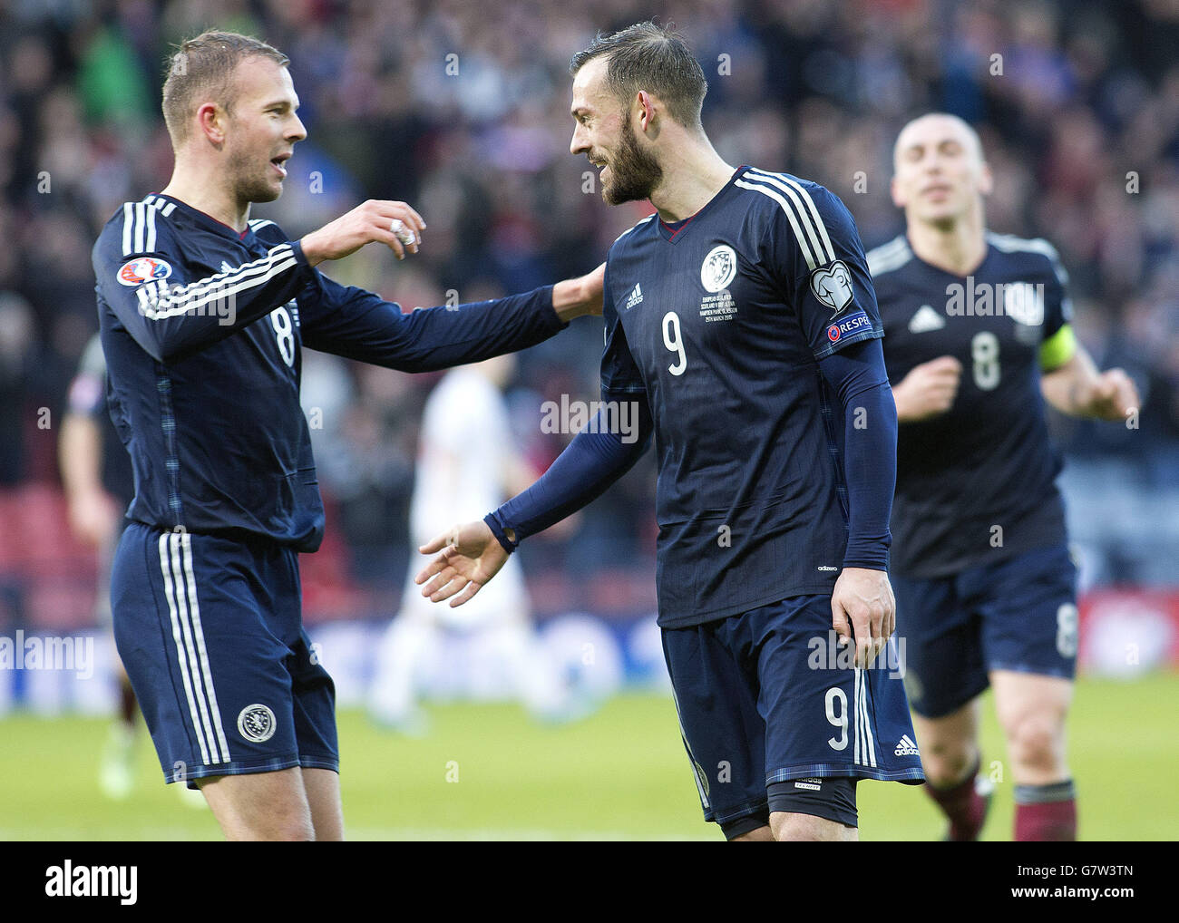 Scotland's Steven Fletcher (right) celebrates his goal to complete his ...