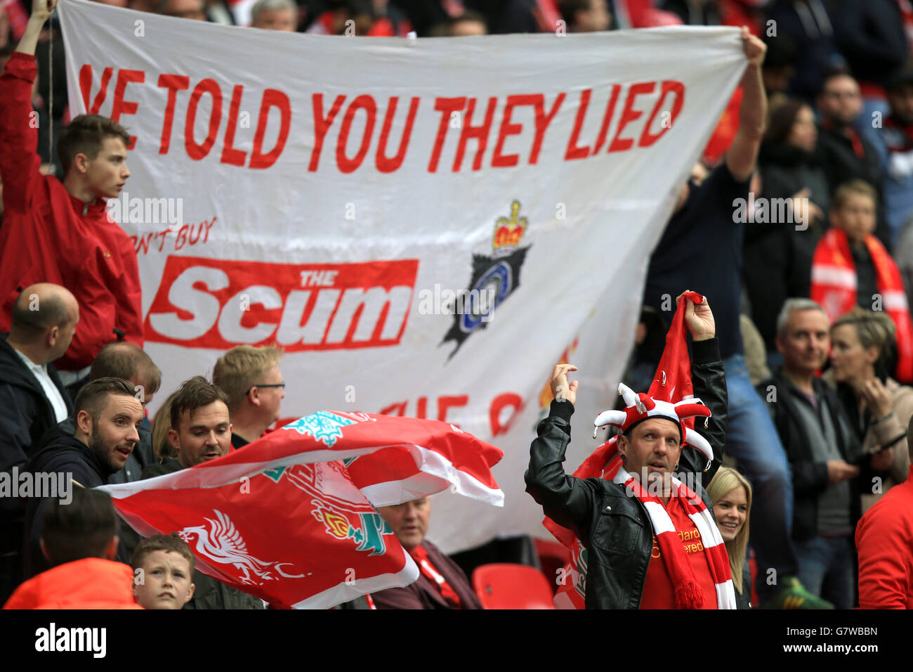 Liverpool fans hold up banners as they cheer on their side in the ...