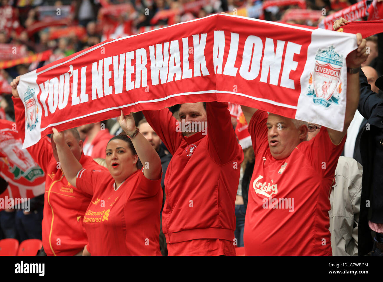Liverpool fans hold up a banner which reads You'll Never Walk Alone as ...