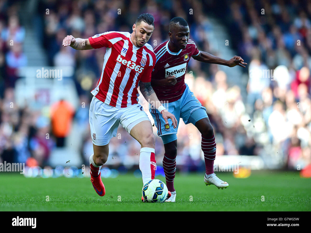 Stoke City's Geoff Cameron (left) and West Ham United's Enner Valencia ...