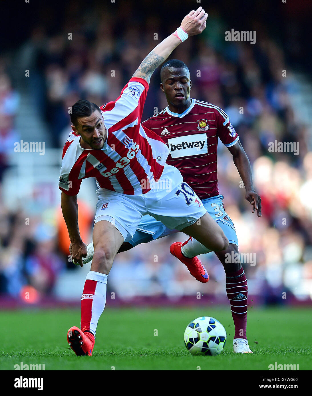 Stoke City's Geoff Cameron (left) and West Ham United's Enner Valencia ...