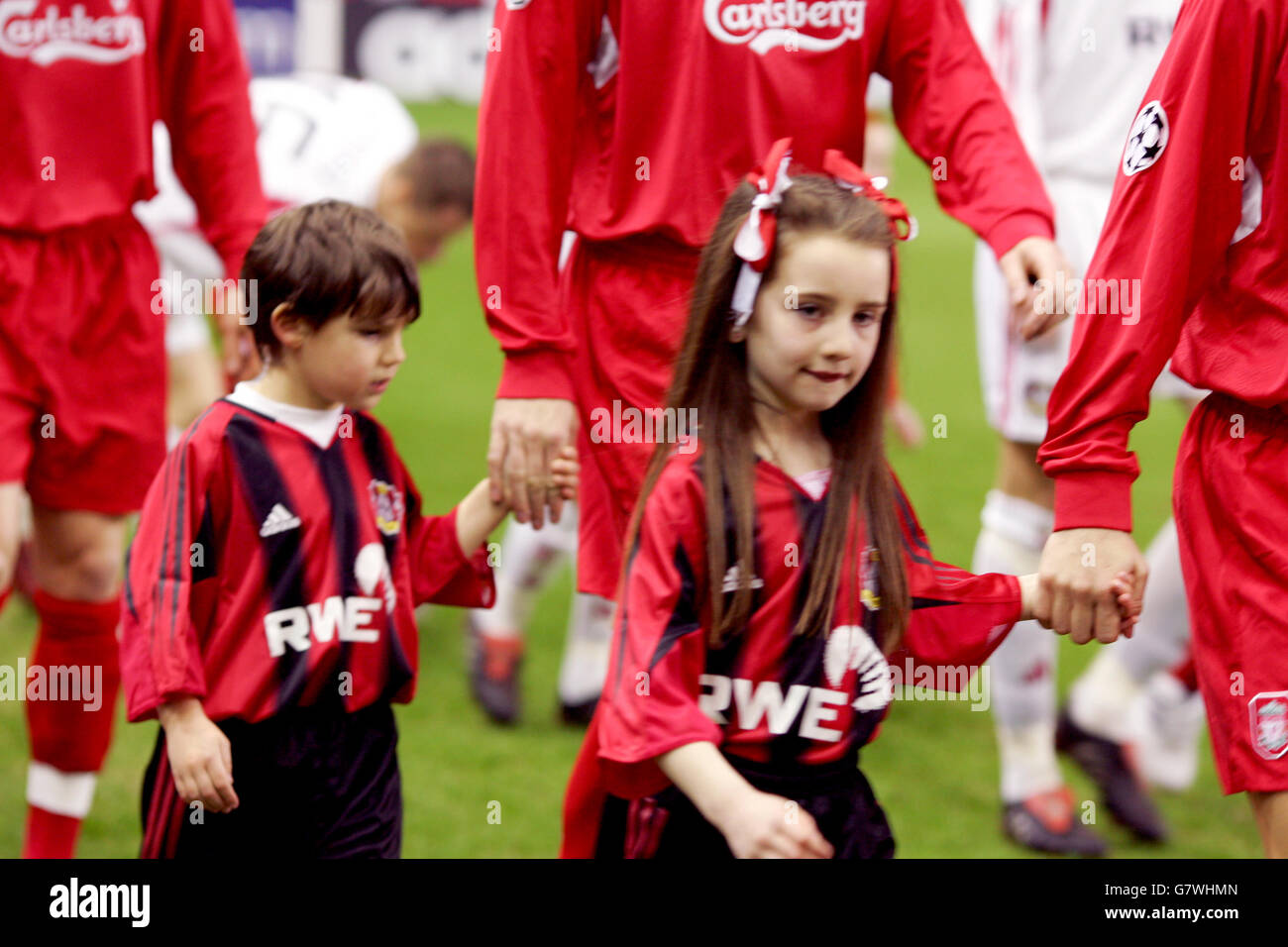 Mascots walk out with the players onto the pitch hi-res stock ...