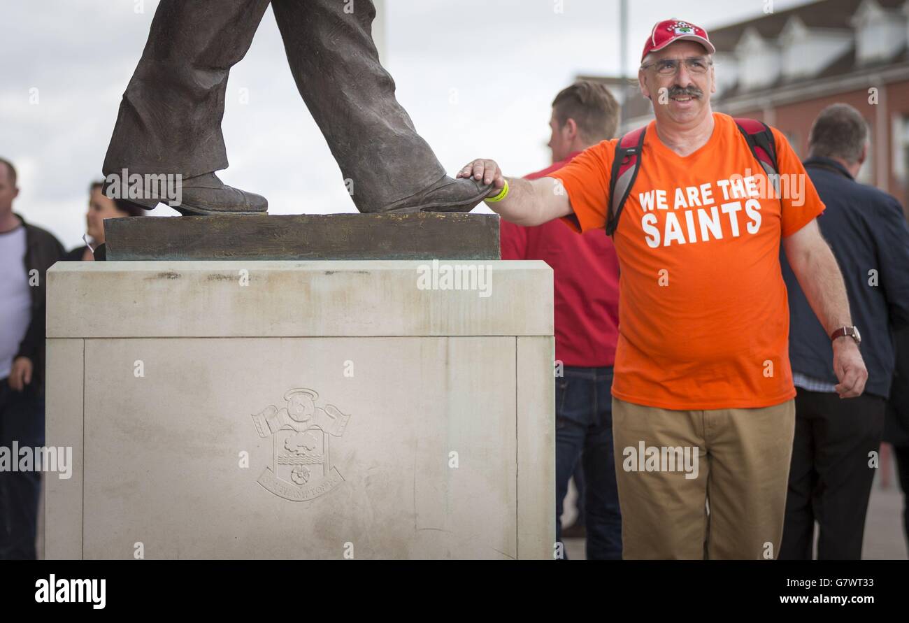 A Southampton fan dressed in Dutch orange touches the toe of Ted Bates ...