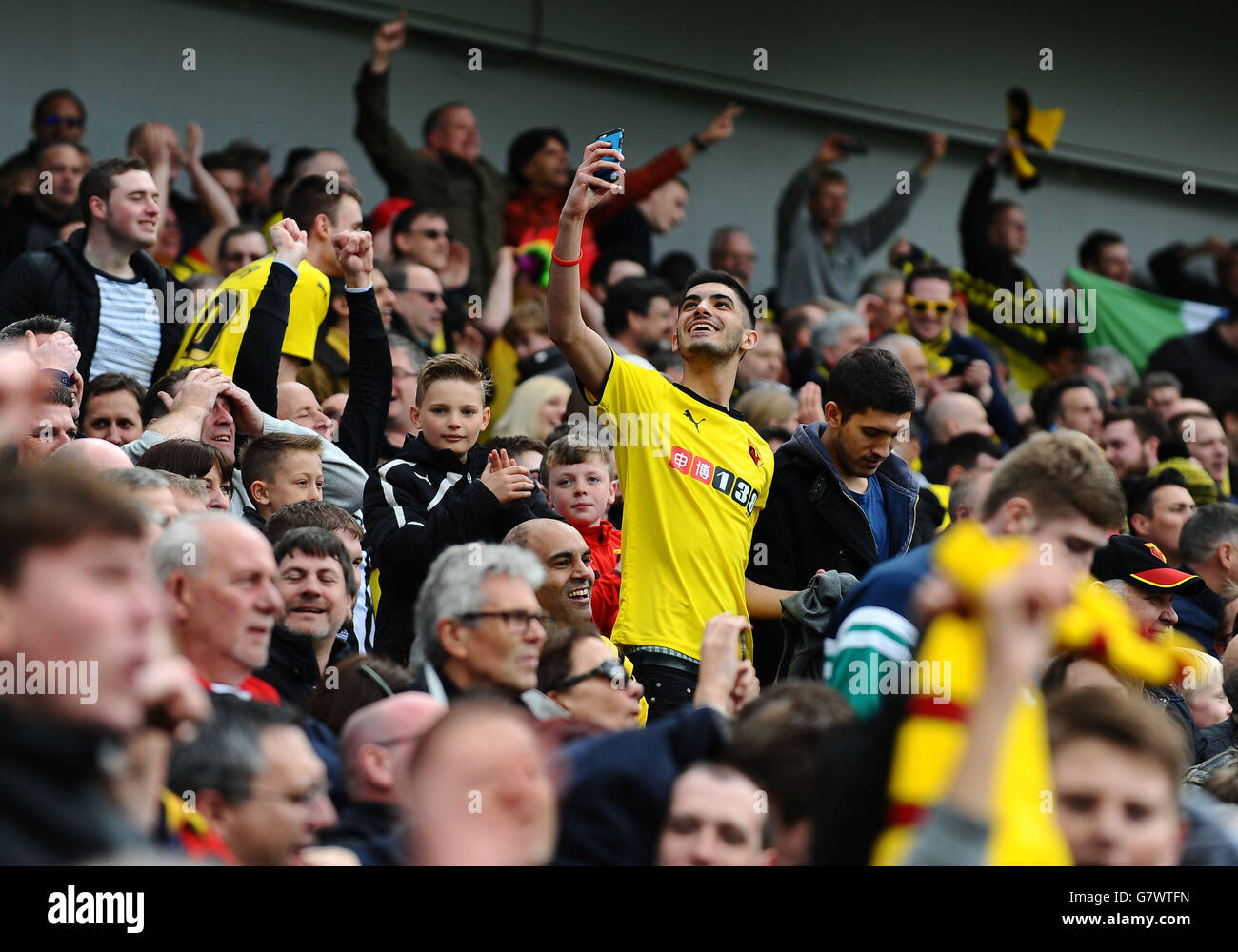 A Watford fan celebrates by taking a selfie after his side scored a ...