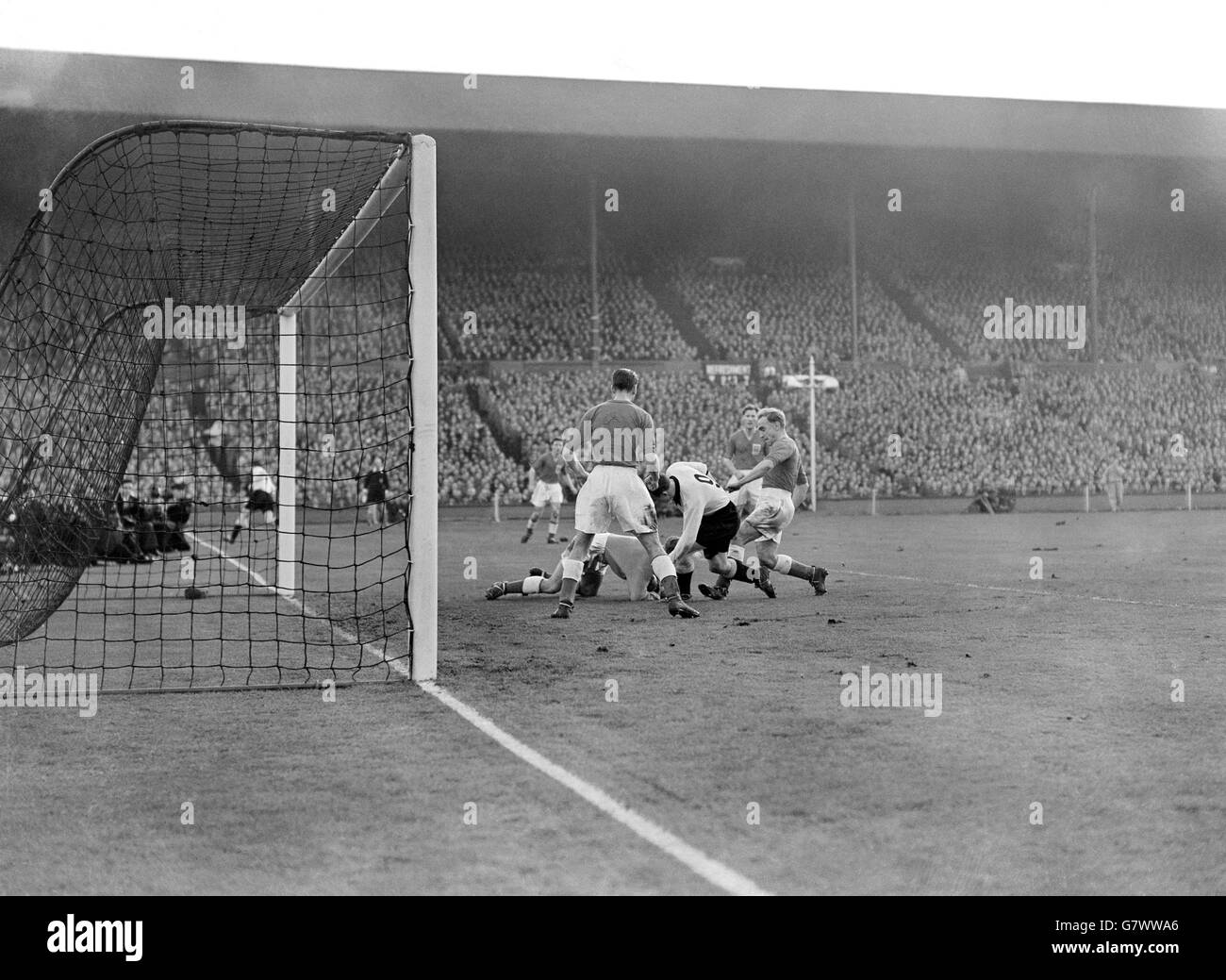 England goalkeeper Bert Williams (l, on floor) saves under pressure ...