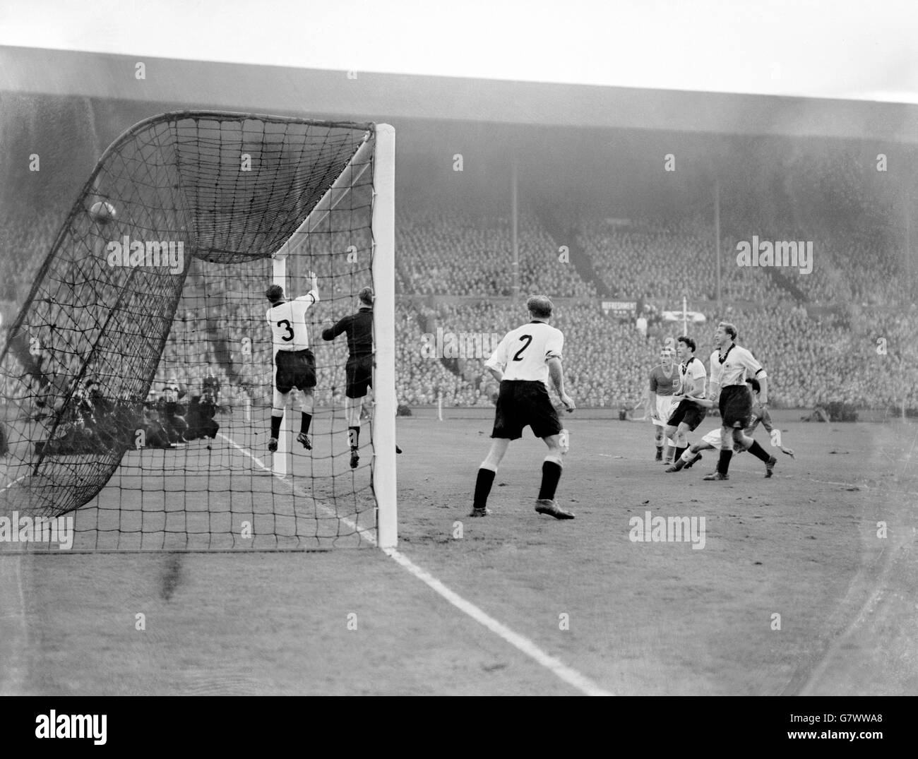 England's Ronnie Allen (r, hidden) fires over the bar as West Germany's ...