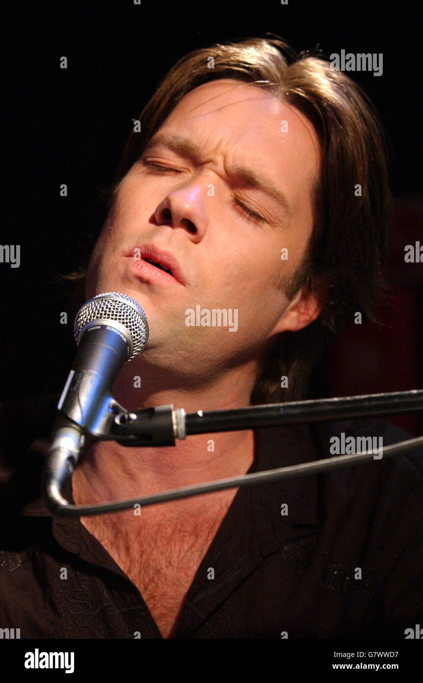 Showbiz music singer musician playing piano head shot singing ...